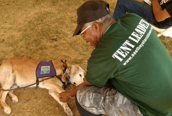 Veteran pets a dog